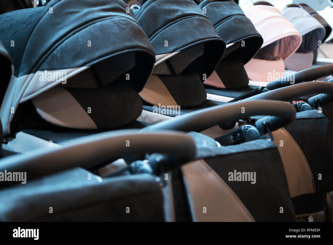 Row of baby strollers in shopping mall. Choosing baby carriage for your ...