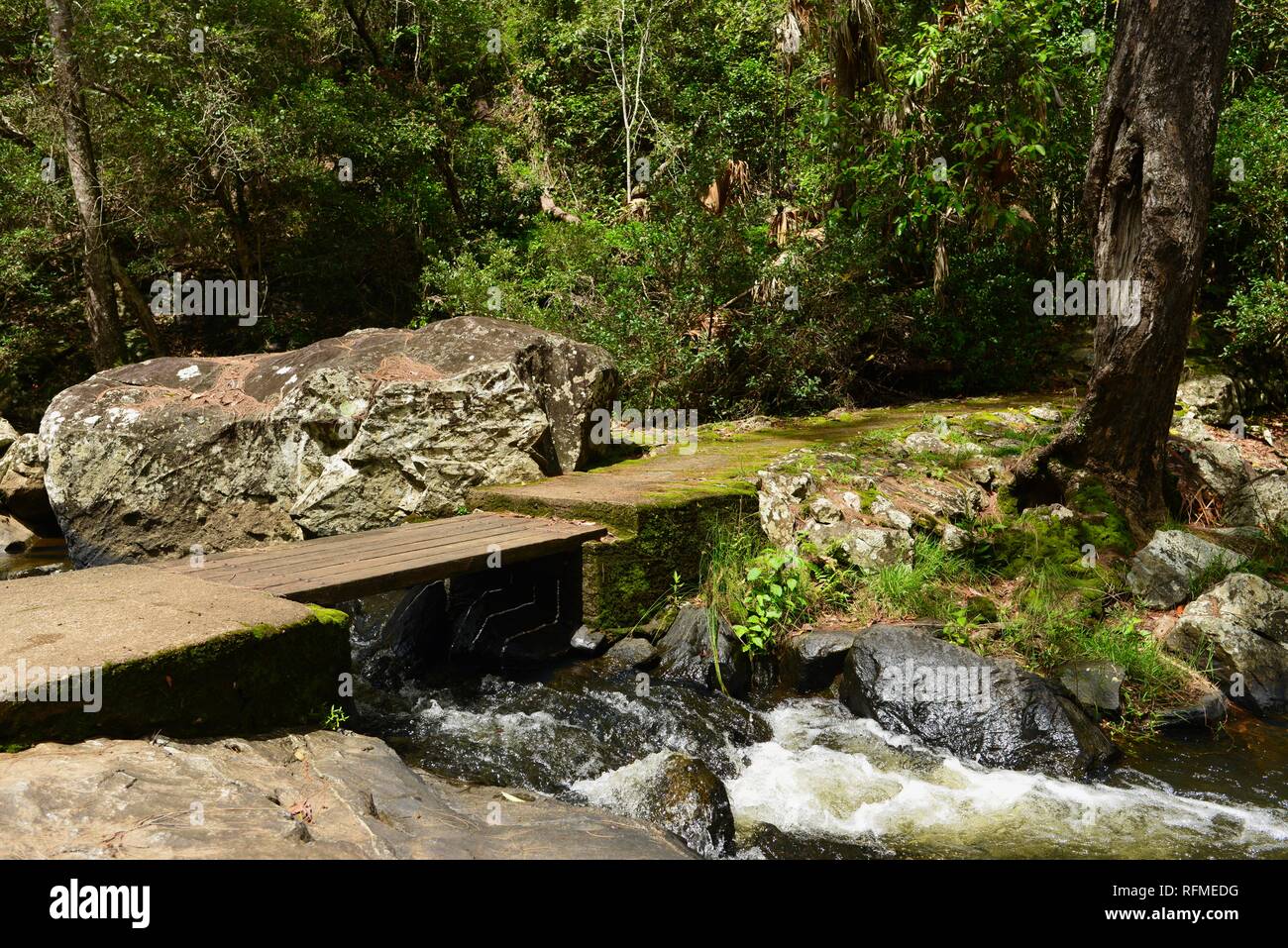A small wooden bridge over a flowing river, Granite bend track to ...