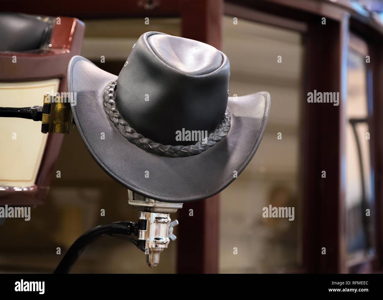 American West rodeo cowboy black leather hat in old wood ranch barn ...