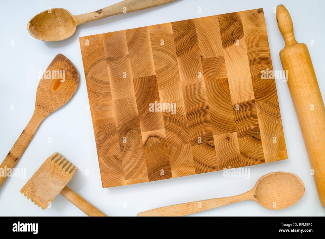 Handmade wooden board and kitchen tools on white background: wooden ...