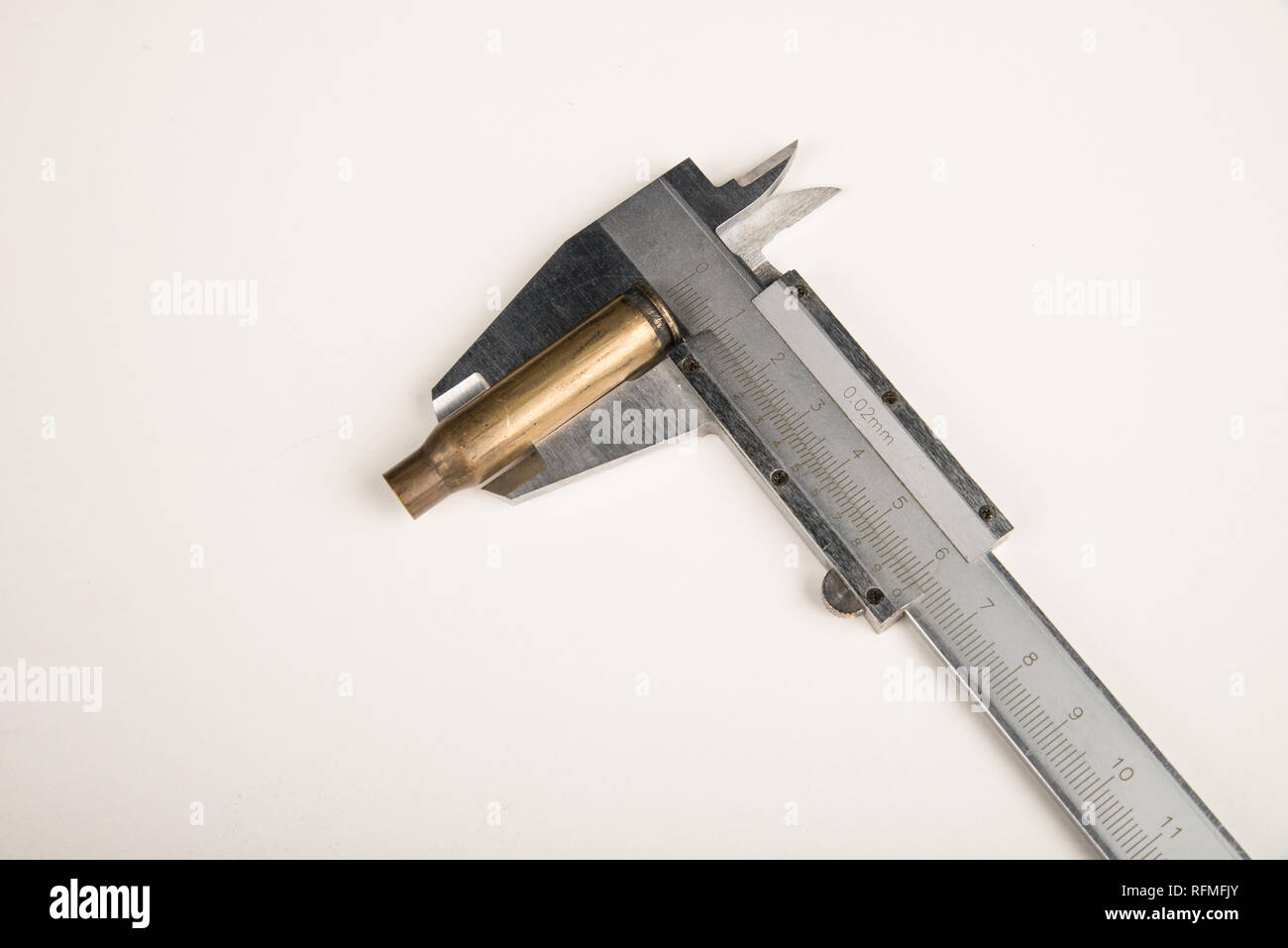 Bullet being measured with a caliper, a concept Stock Photo - Alamy