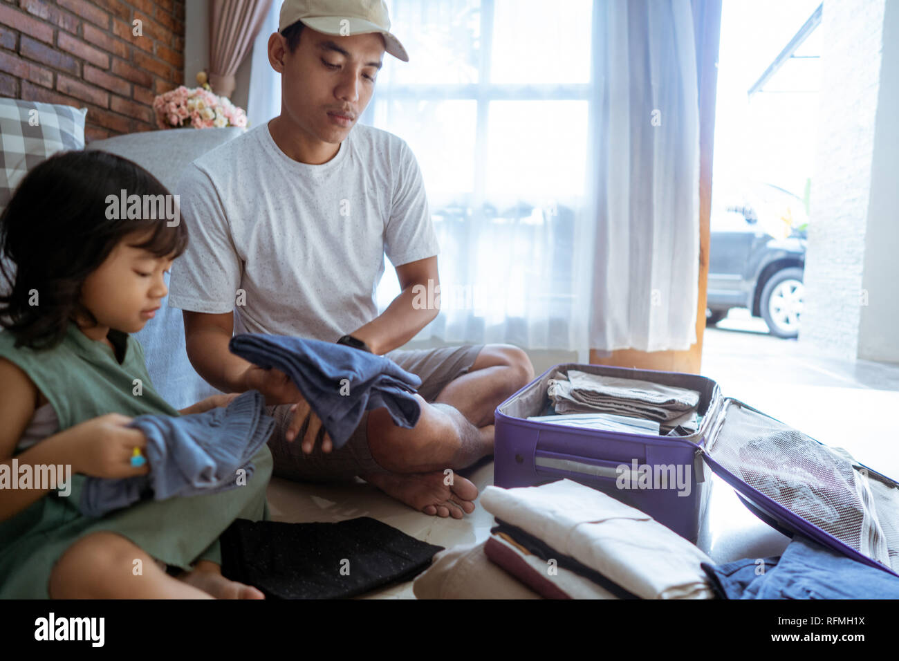 portrait of a father and daughter prepare clothes together Stock Photo ...