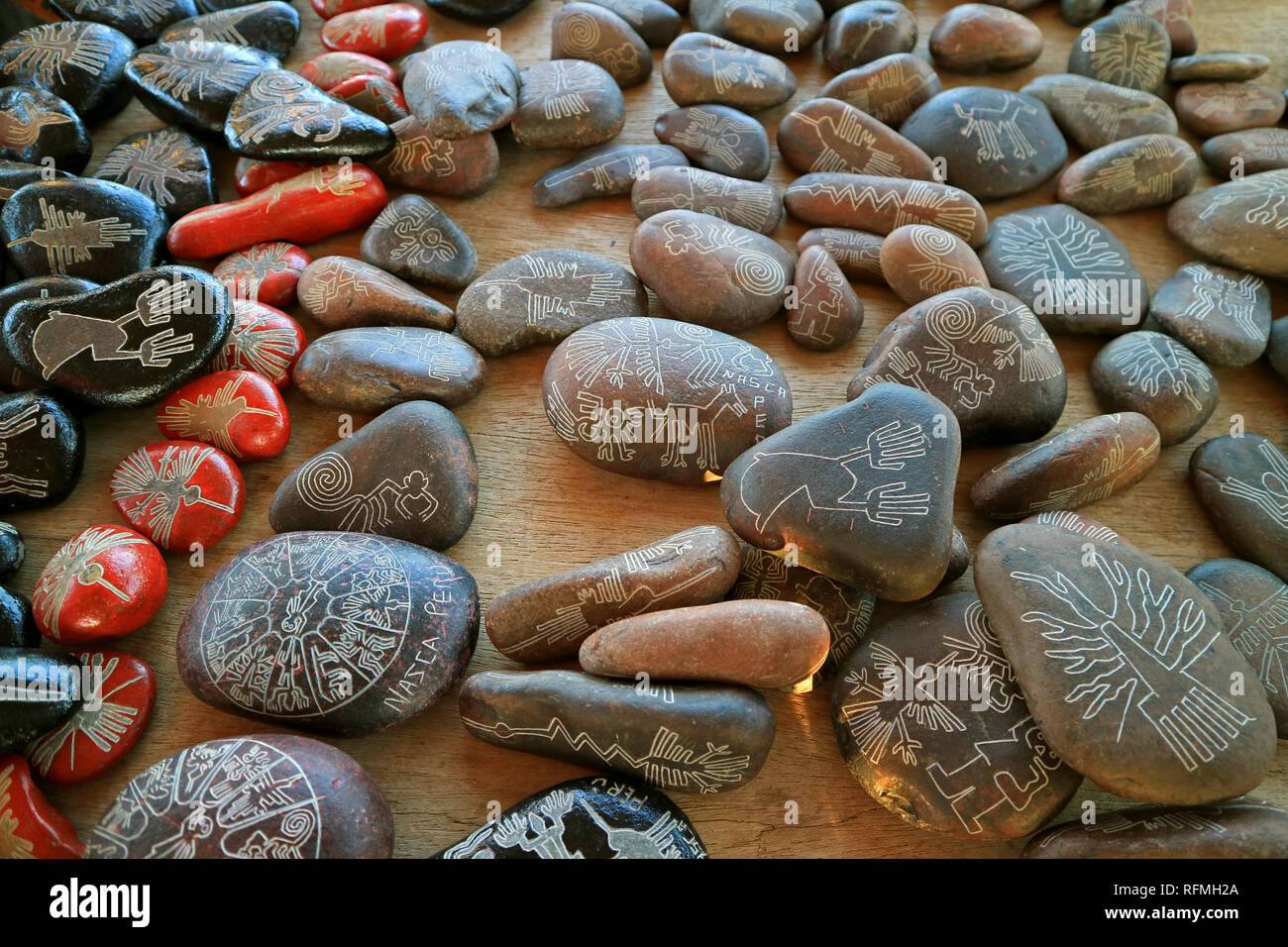 Souvenir of Nazca lines carved into the various size of pebble stones ...
