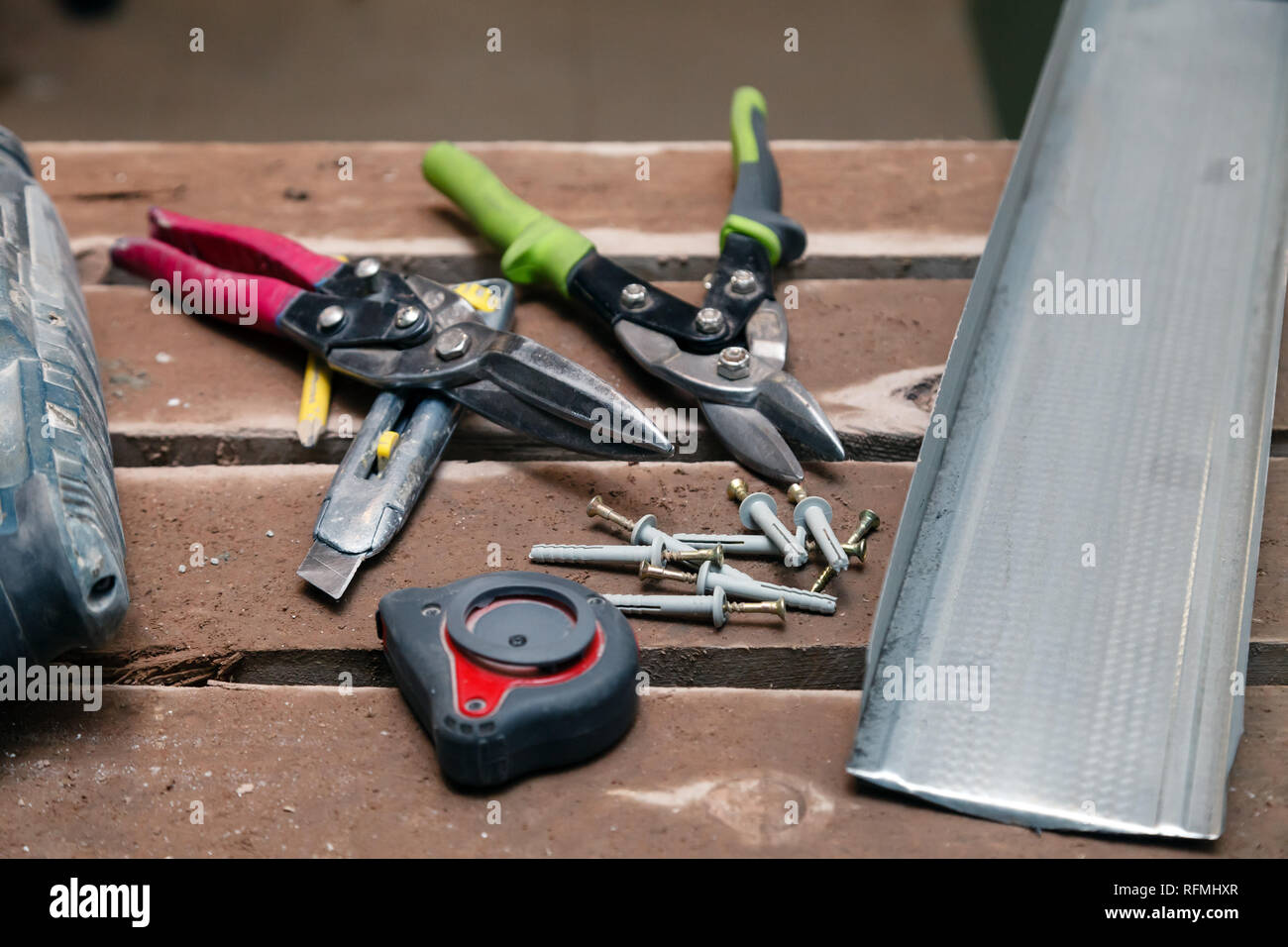 Closeup dusty construction building tools on the scaffolding, drill ...