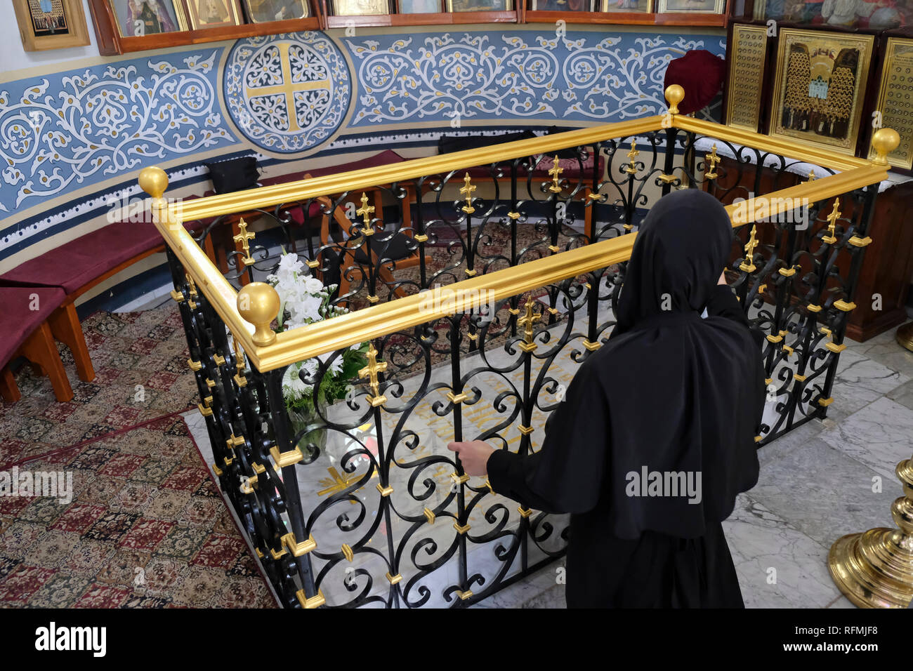 Eastern Orthodox nun praying inside the Russian Orthodox Church of the ...