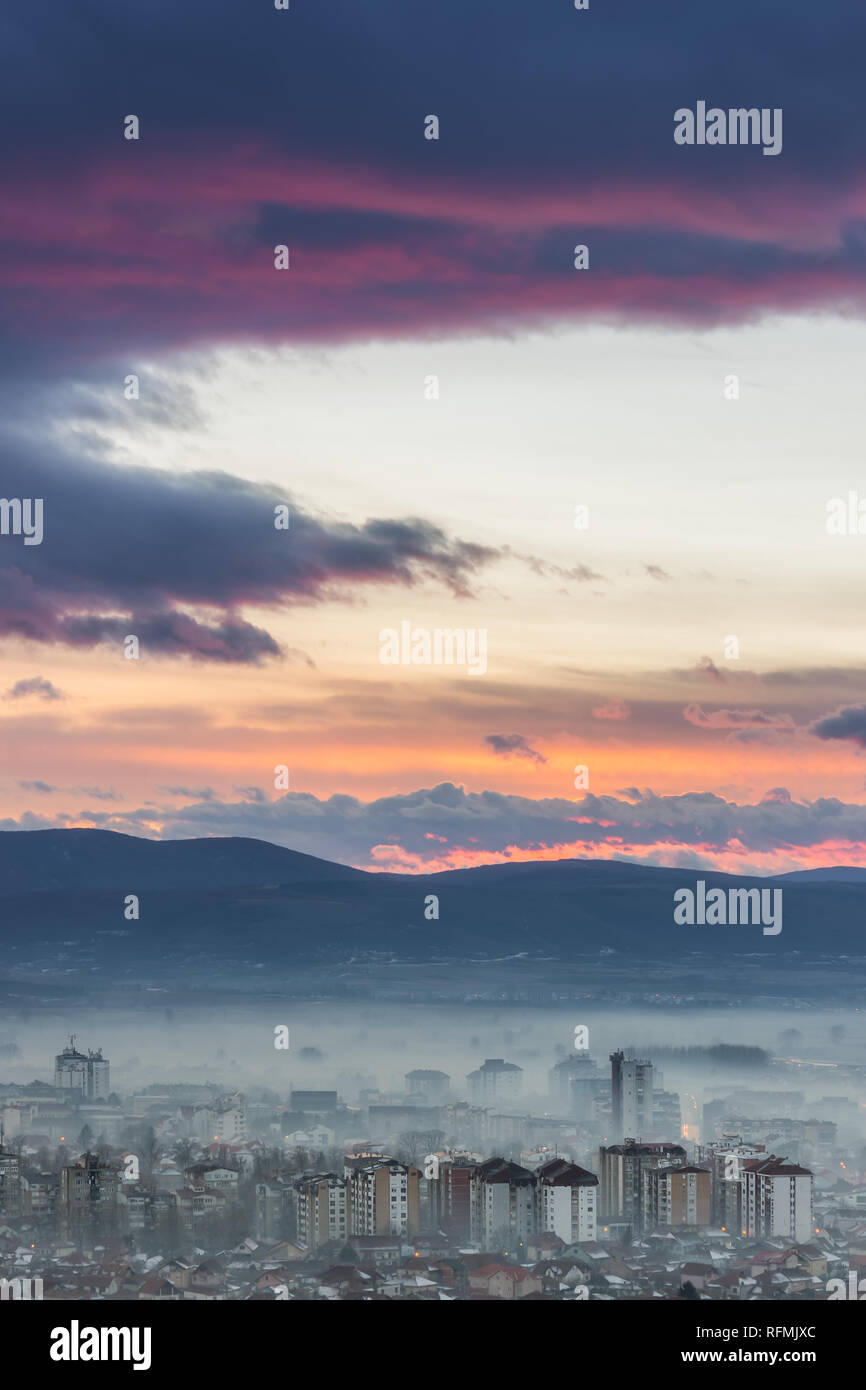 Vertical, soft view of distant city covered by mist and beautiful ...