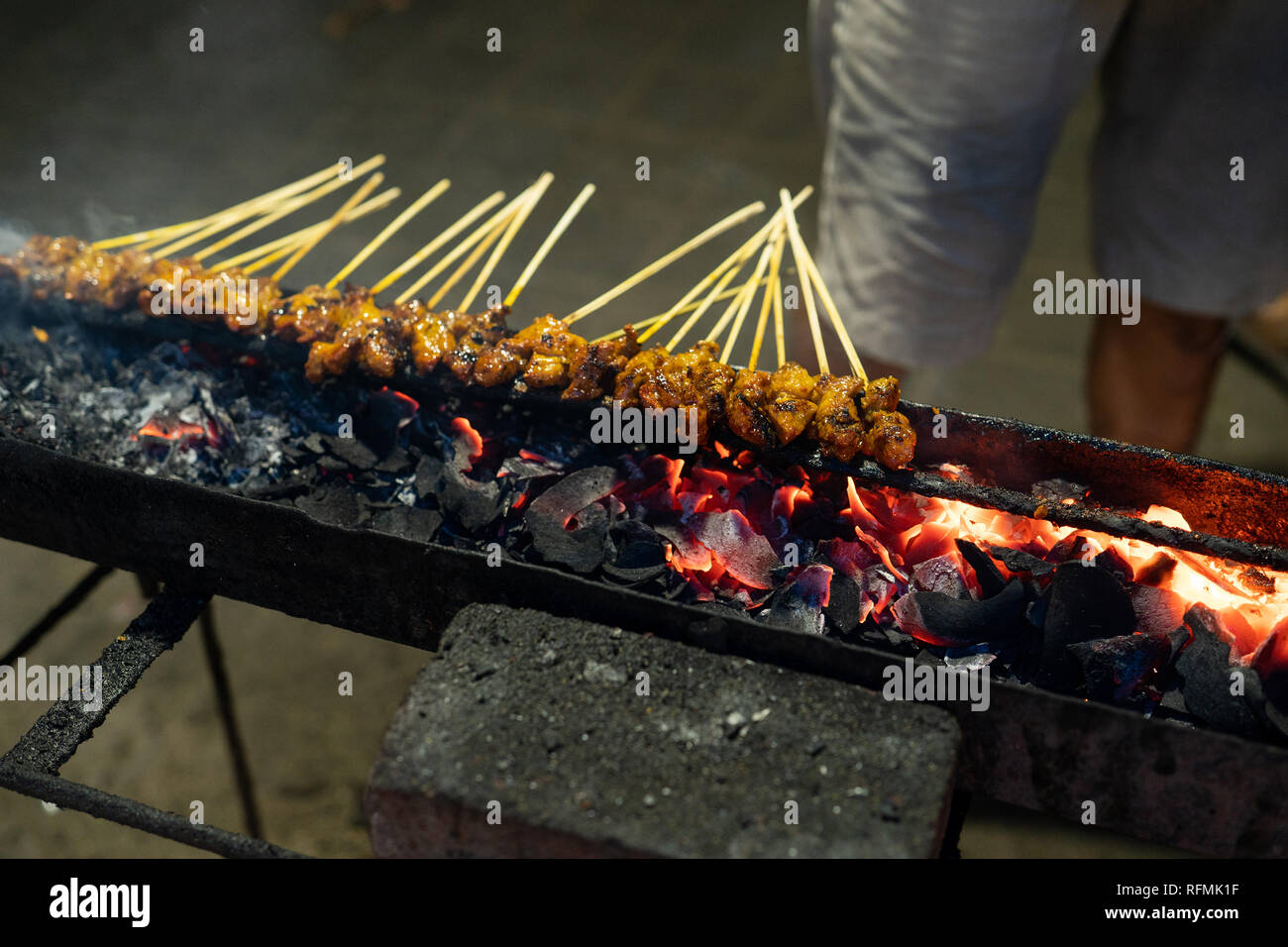 chicken sate on the grill shelf with fire on charcoal until well done ...