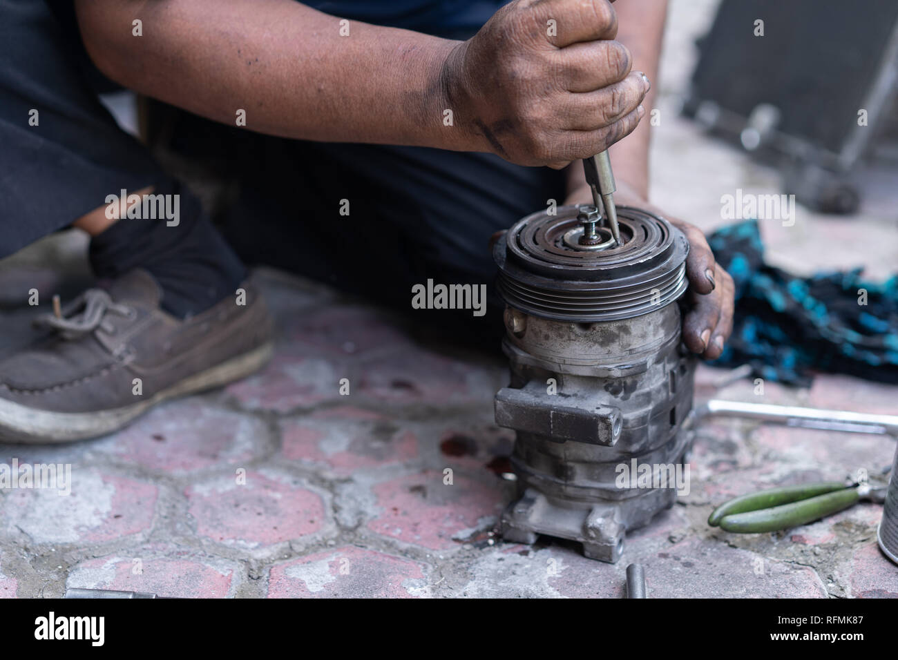 a mechanic uses pliers to unlock pulley Stock Photo - Alamy