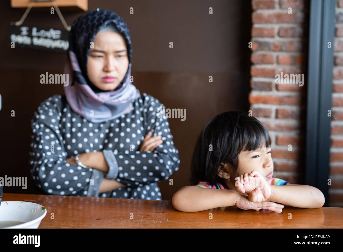 sad kid and mad, mother at the back Stock Photo - Alamy
