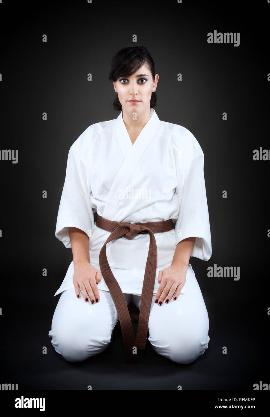 Karate woman in basic karate pose on black background Stock Photo - Alamy