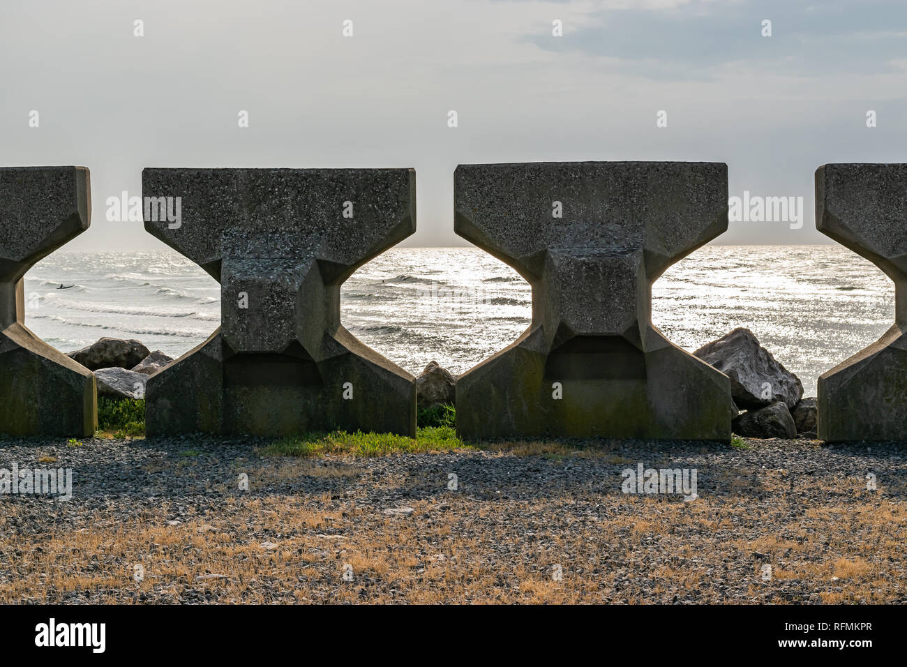 View of concrete blocks on the breakwater, sea, dark storm clouds and ...