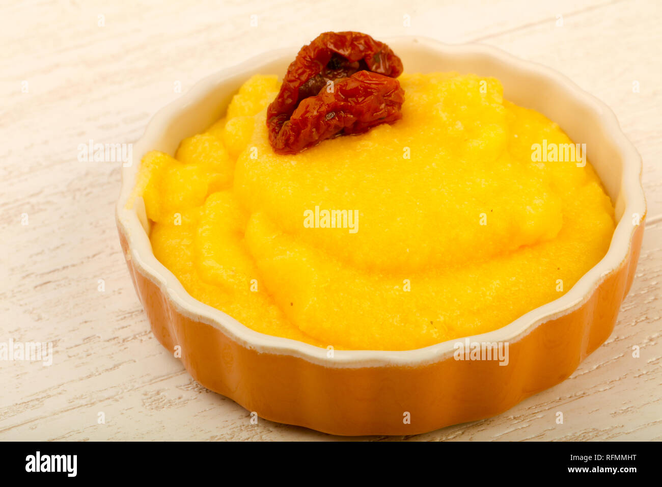 Polenta with dry tomato Stock Photo - Alamy