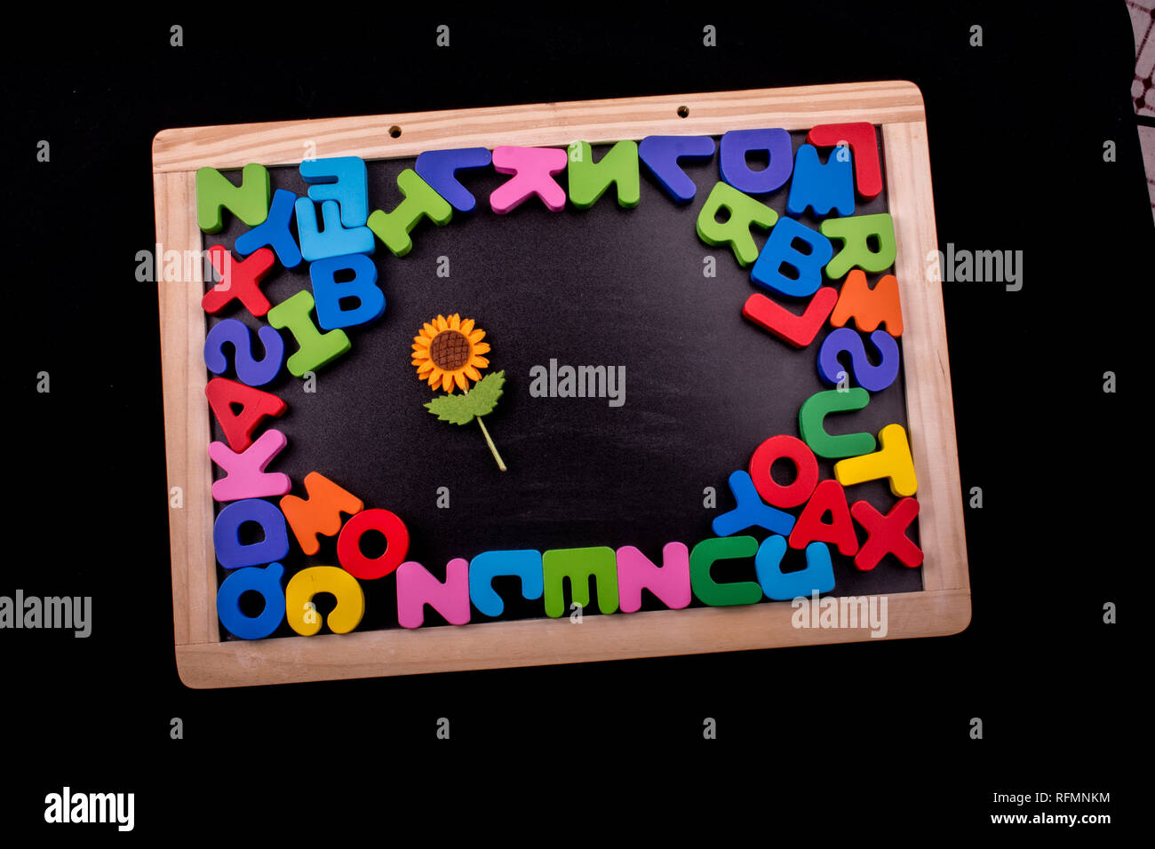 Fake flower and colorful Letters of Alphabet made of wood Stock Photo ...