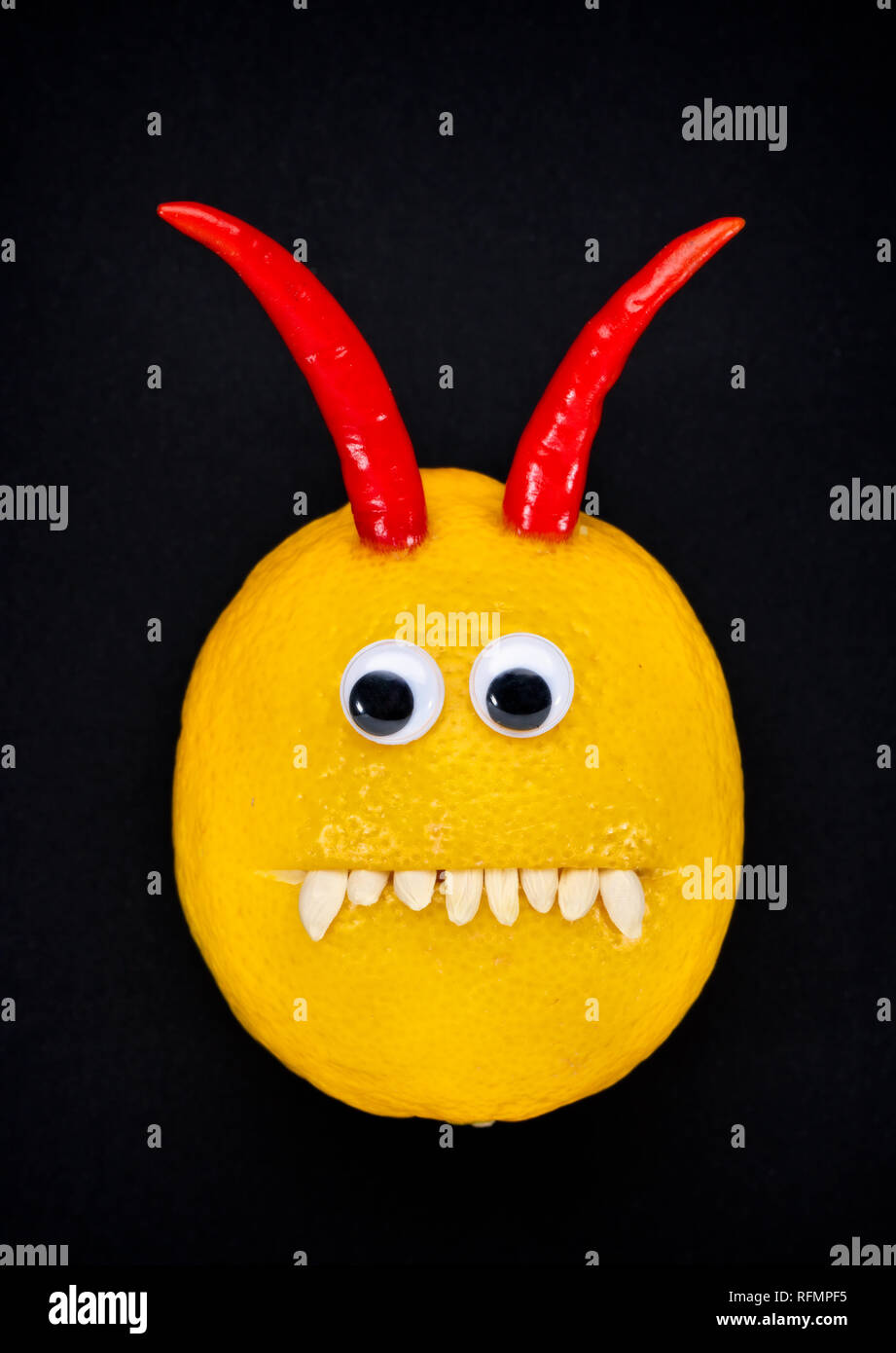 devil lemon face with eyes, chili horns and teeth Stock Photo - Alamy