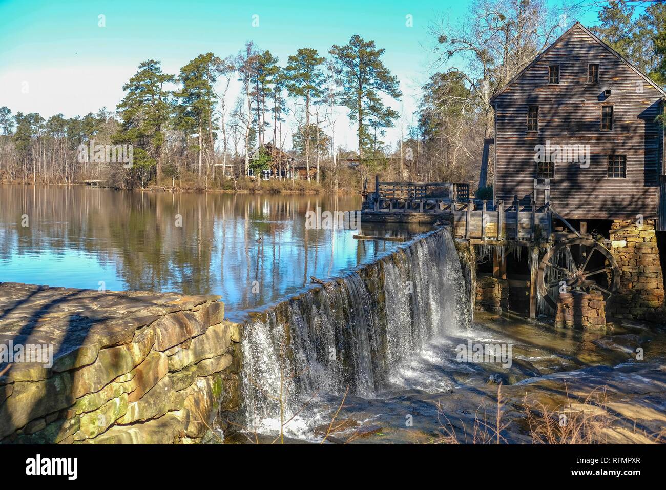 Scenic winter view of the waterfall and dam by the old gristmill at ...