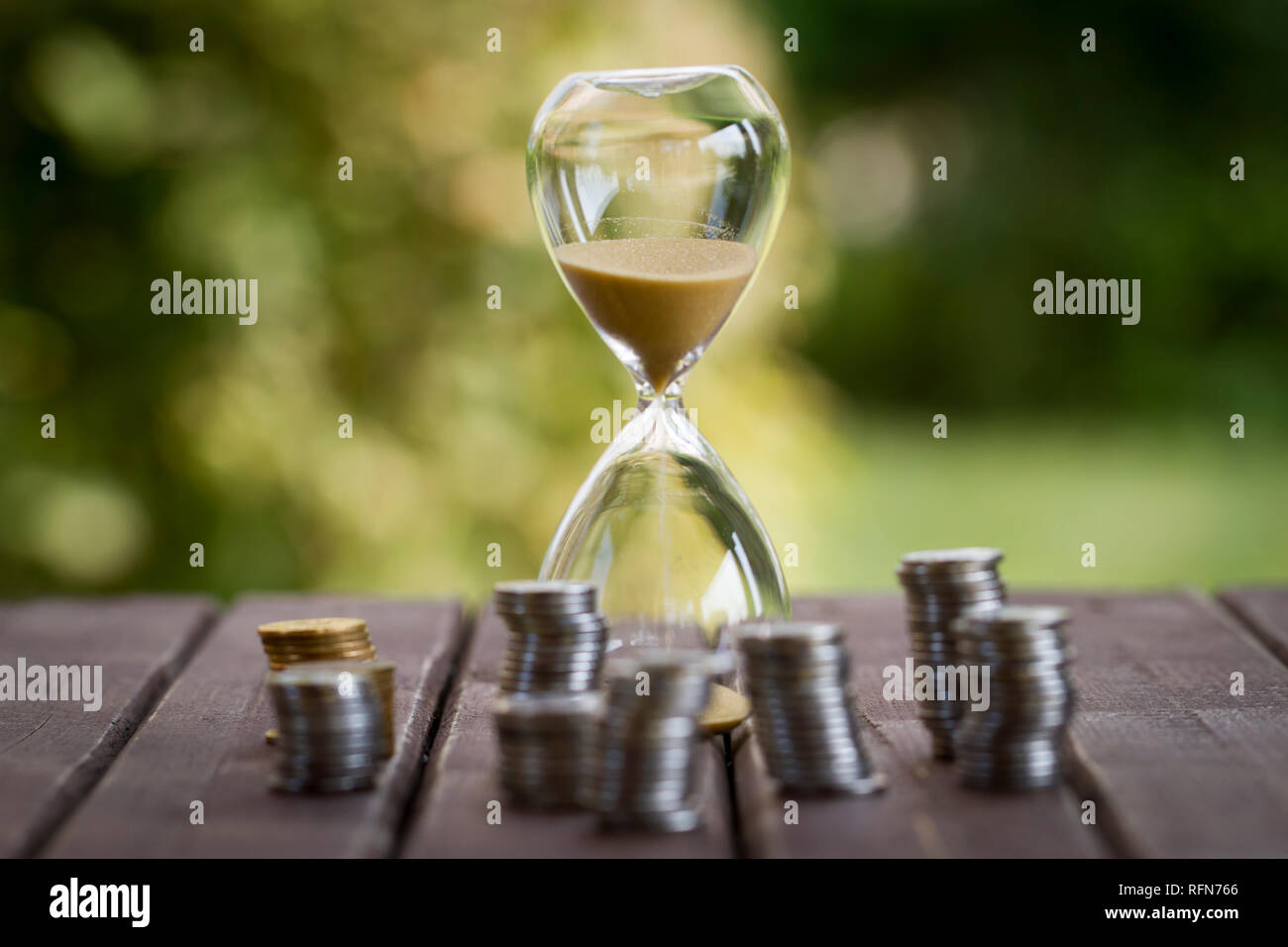 Hourglass and money, time and wealth accumulation Stock Photo - Alamy