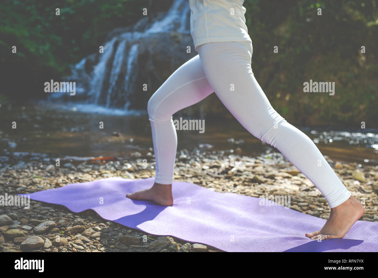 Beautiful girls are playing yoga at the park. Among the natural ...