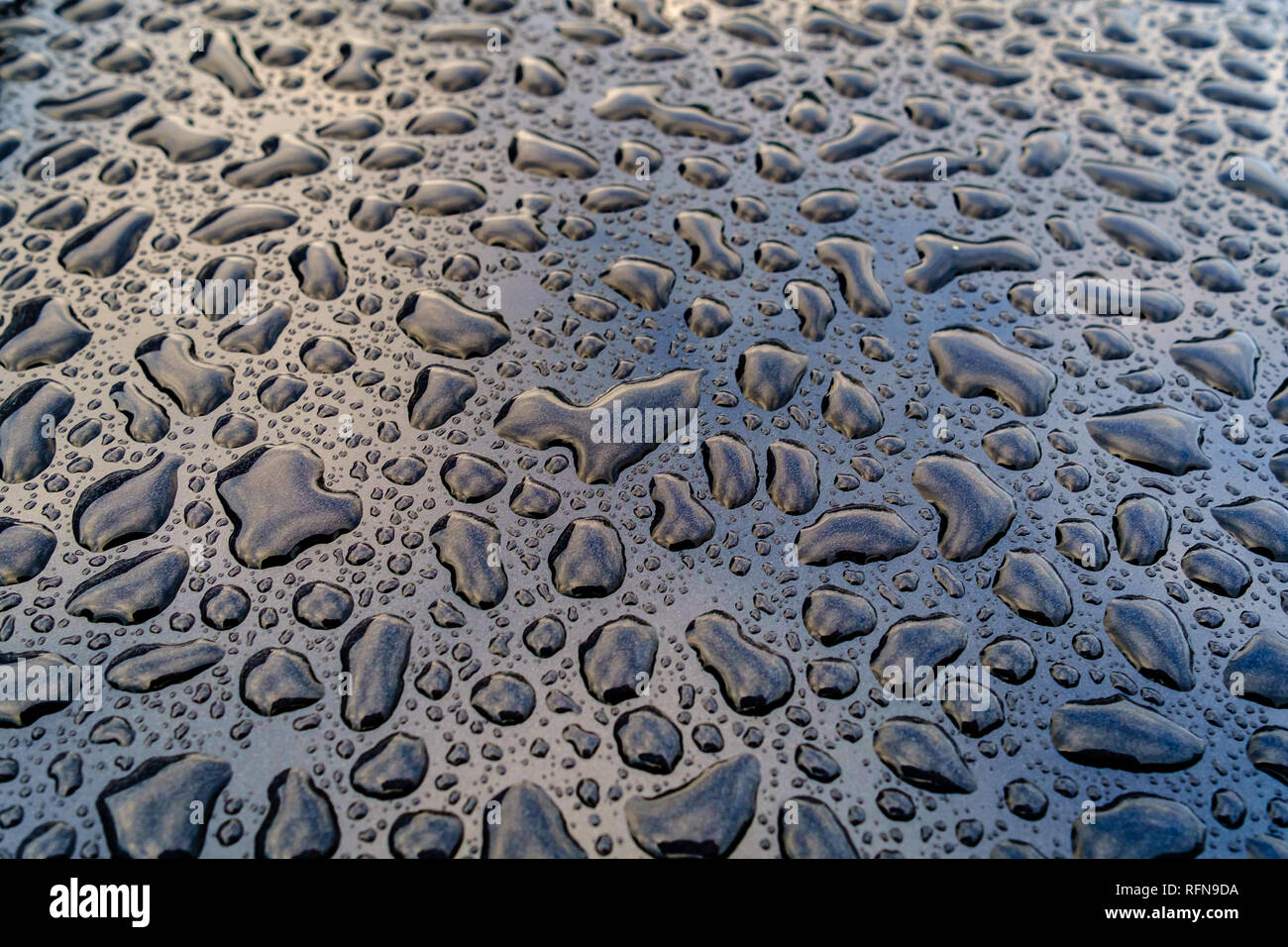 big raindrops on black metal surface background Stock Photo - Alamy