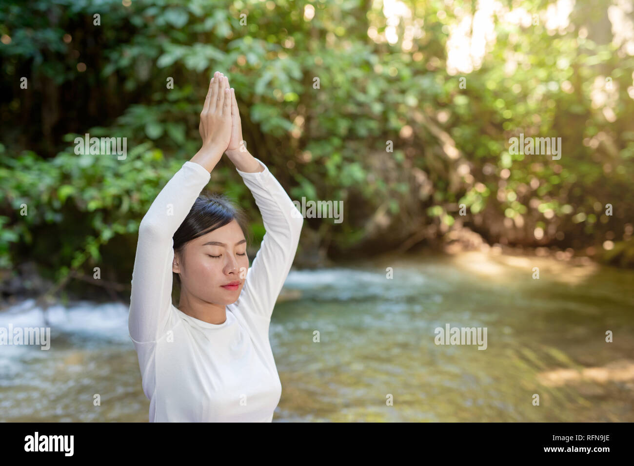 Beautiful girls are playing yoga at the park. Among the natural ...