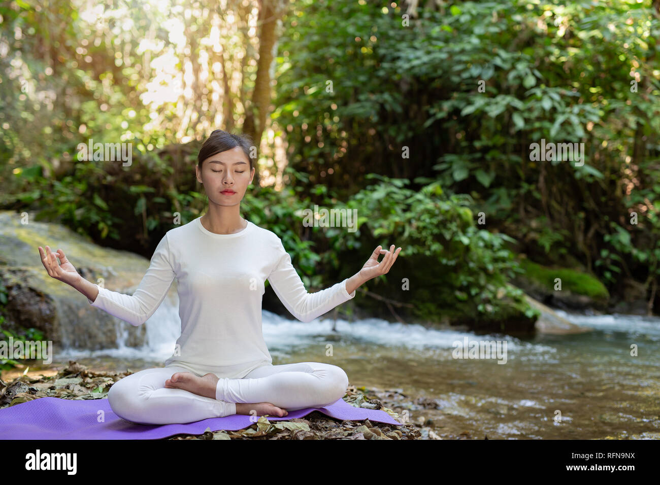 Beautiful girls are playing yoga at the park. Among the natural ...