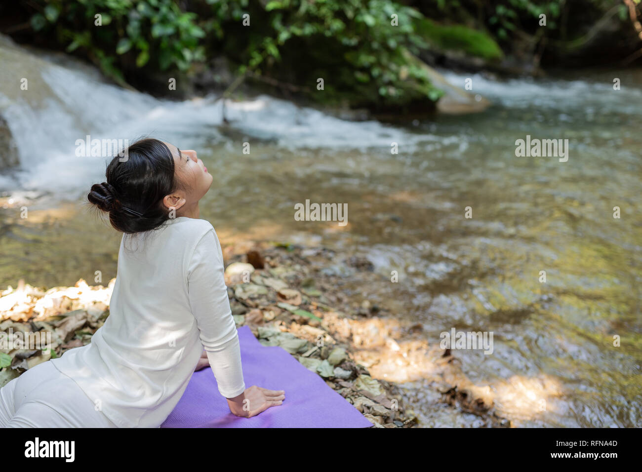 Beautiful girls are playing yoga at the park. Among the natural ...