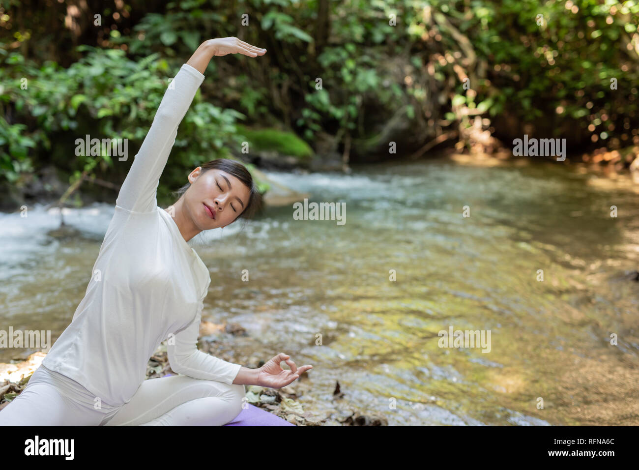 Beautiful girls are playing yoga at the park. Among the natural ...