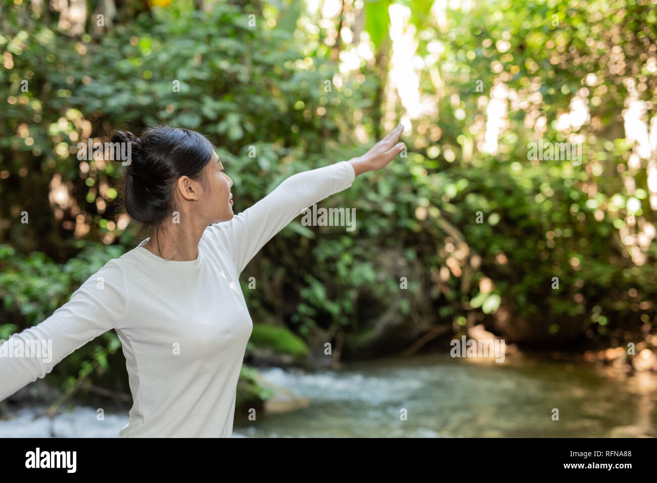 Beautiful girls are playing yoga at the park. Among the natural ...
