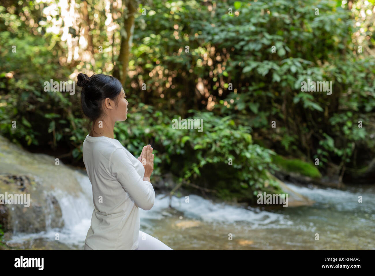 Beautiful girls are playing yoga at the park. Among the natural ...