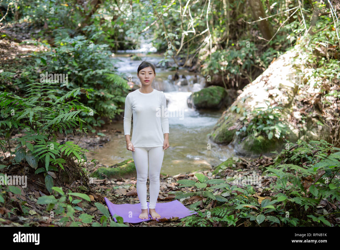 Beautiful girls are playing yoga at the park. Among the natural ...