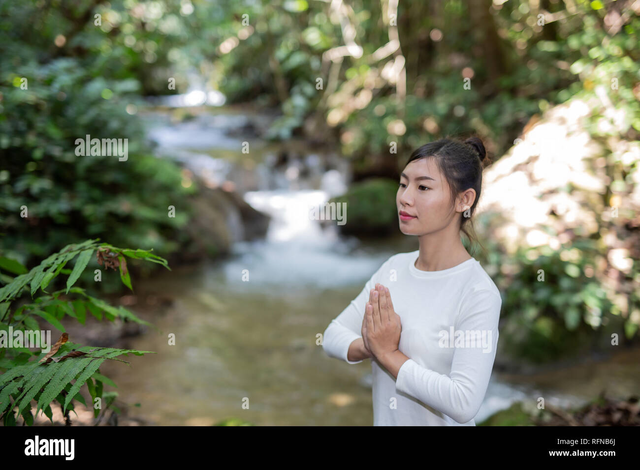 Beautiful girls are playing yoga at the park. Among the natural ...