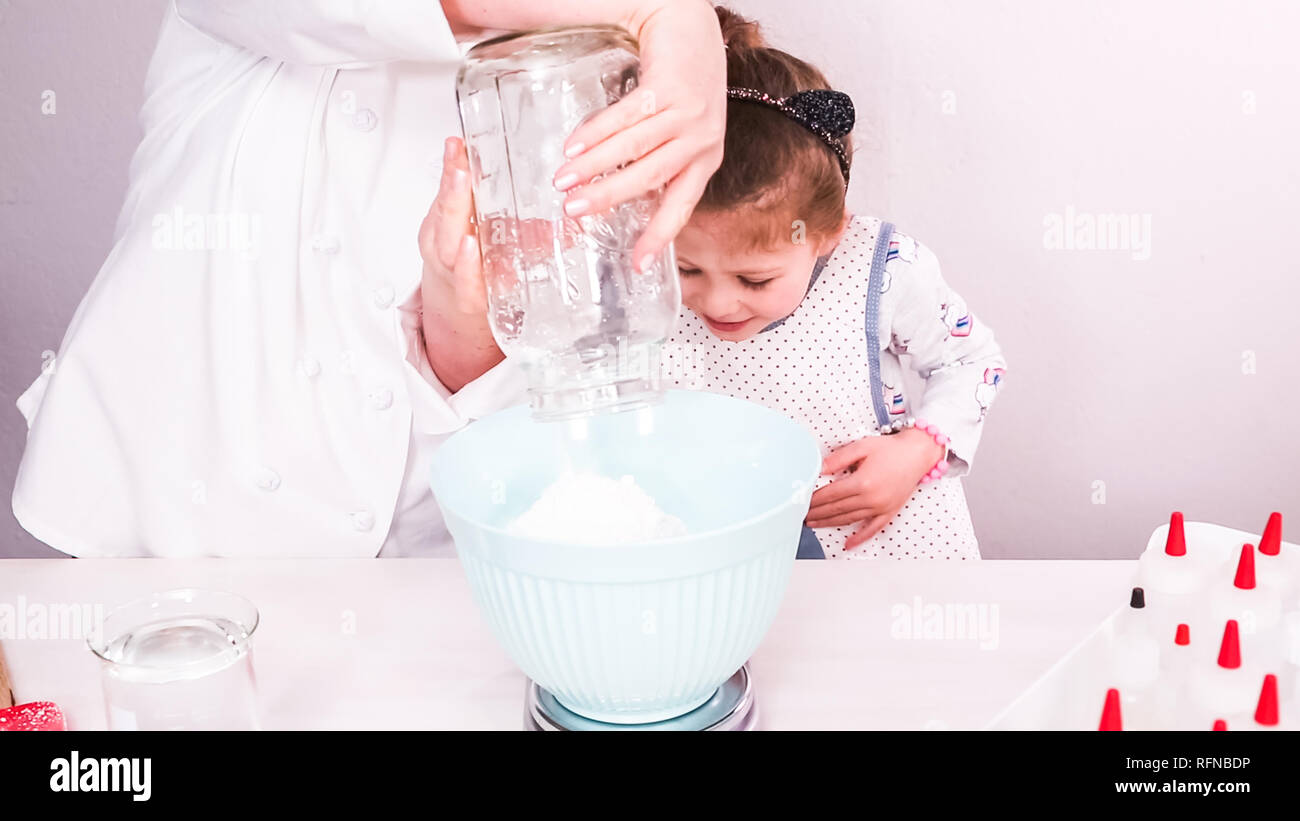 Step by step. Mixing royal icing to decorate sugar cookies Stock Photo ...