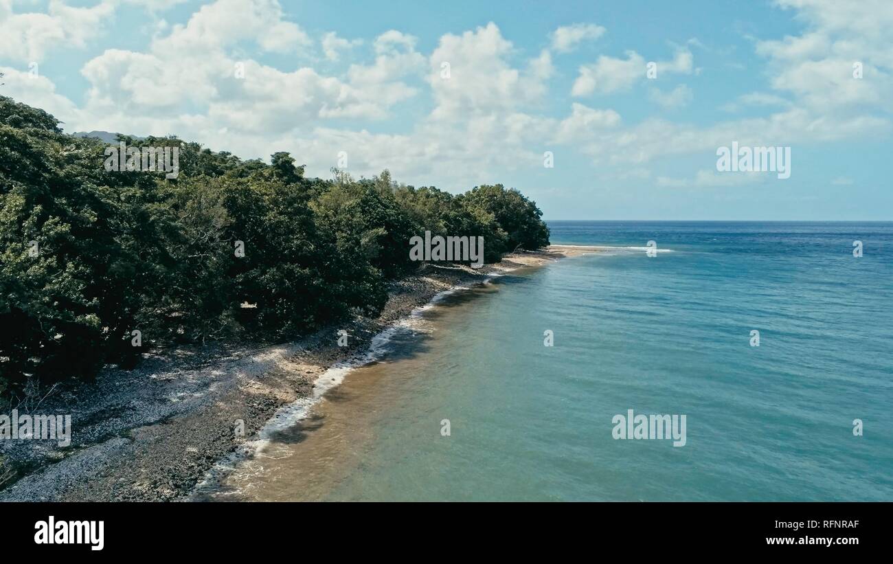 aerial drone image of a remote south pacific island with sandy beach ...