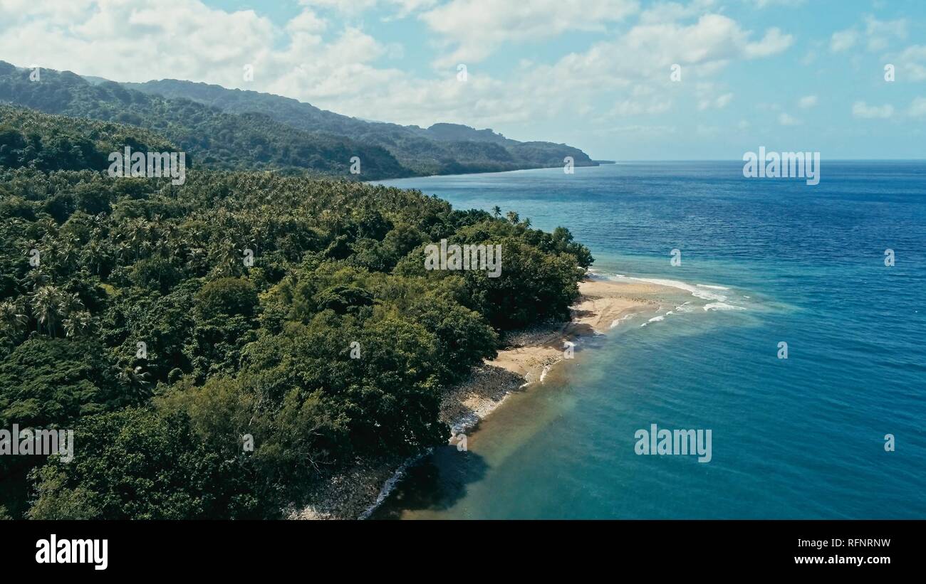 aerial drone image of a remote south pacific island with sandy beach ...