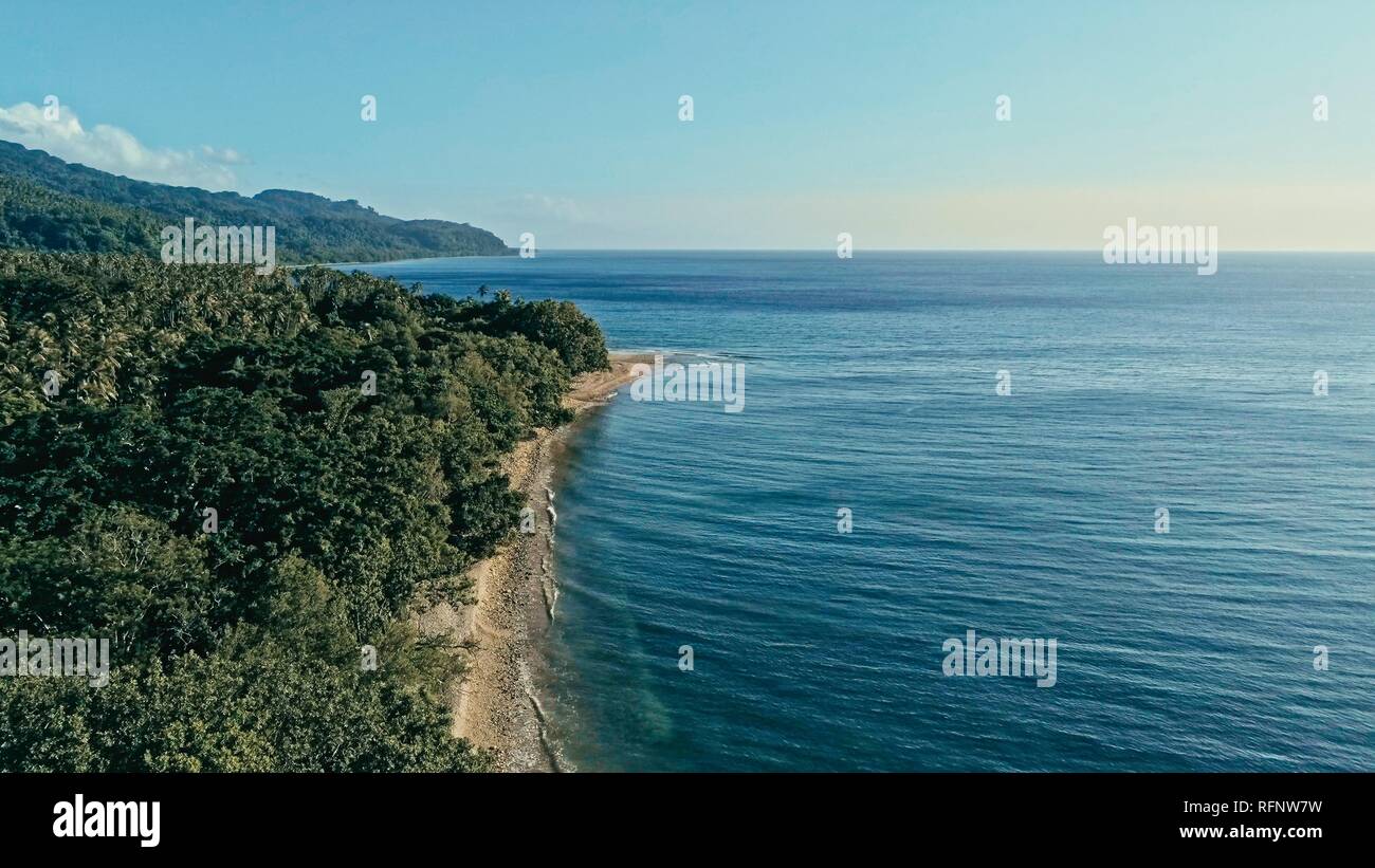aerial drone image of a remote south pacific island with sandy beach ...
