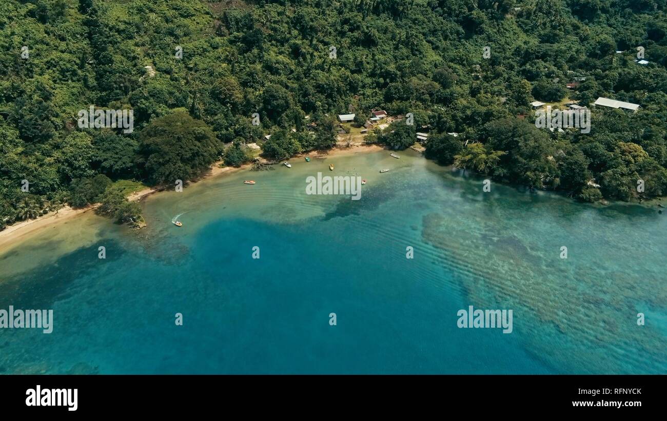 aerial drone image of a south pacific village on a remote island with a ...
