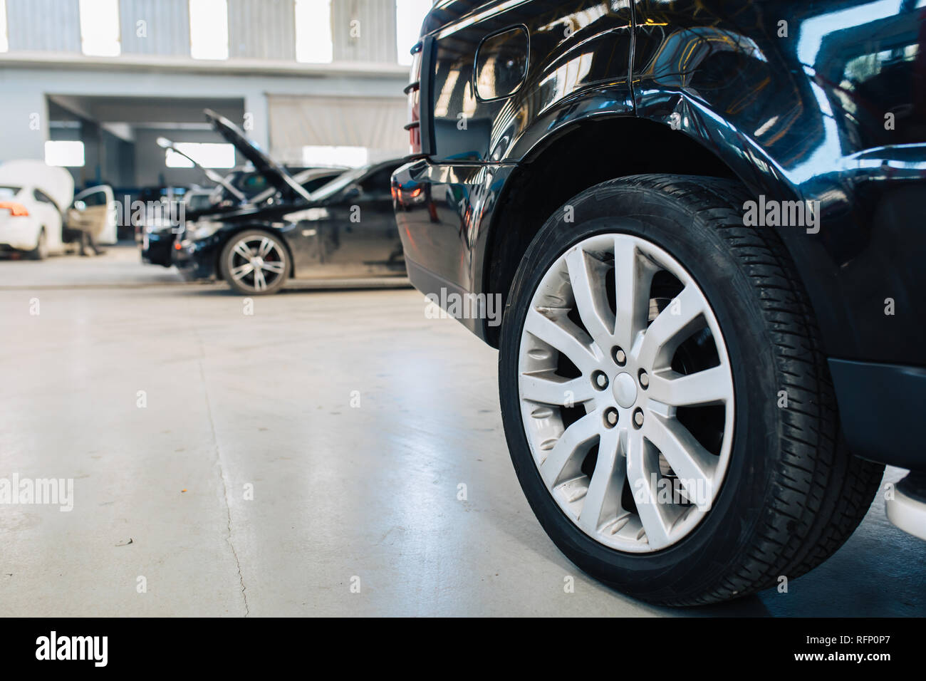 Modern Cars in repair maintenance auto service garage Stock Photo - Alamy