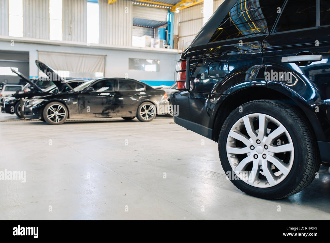 Modern Cars in repair maintenance auto service garage Stock Photo - Alamy