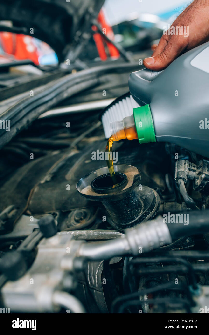 Auto mechanic working in garage during the maintenance of engine ...