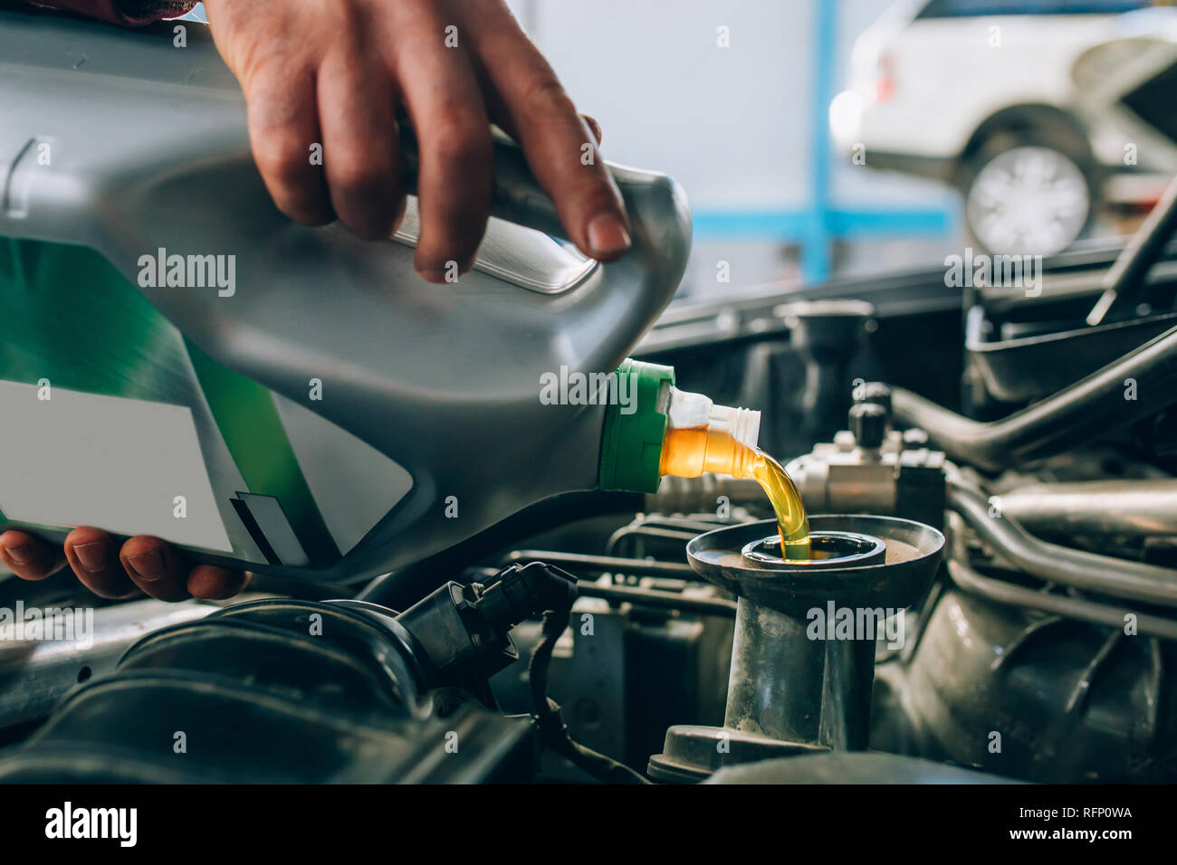 Auto mechanic working in garage during the maintenance of engine ...