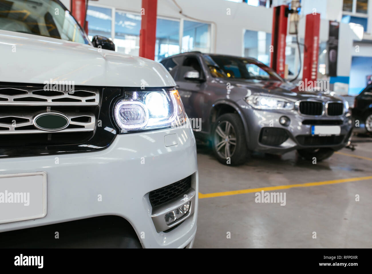 Modern Cars in repair maintenance auto service garage Stock Photo - Alamy