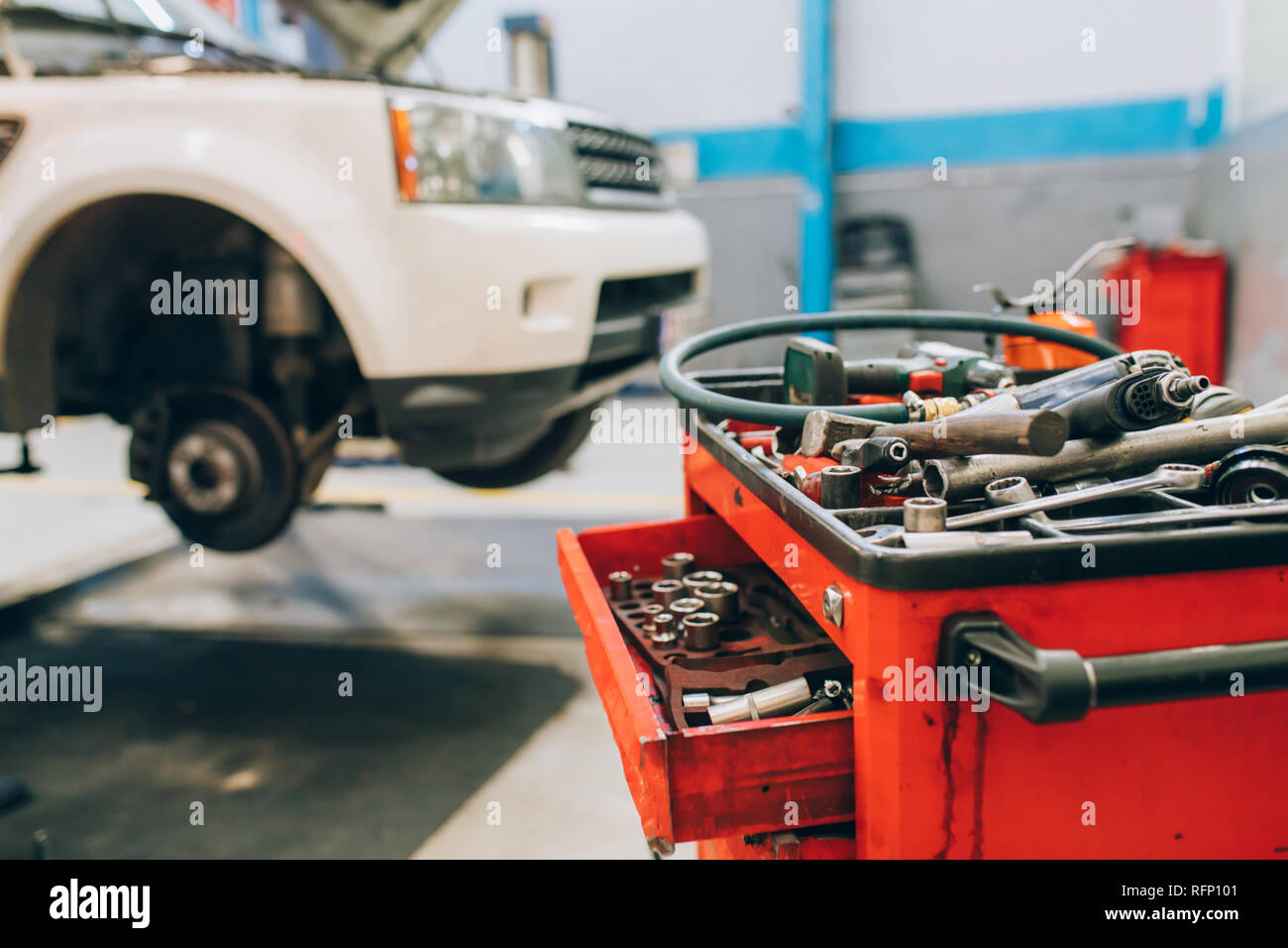 Car repair maintenance service. Car raised on car lift in autoservice ...