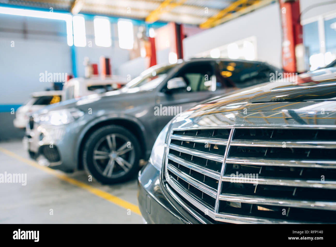 Modern Cars in repair maintenance auto service garage Stock Photo - Alamy