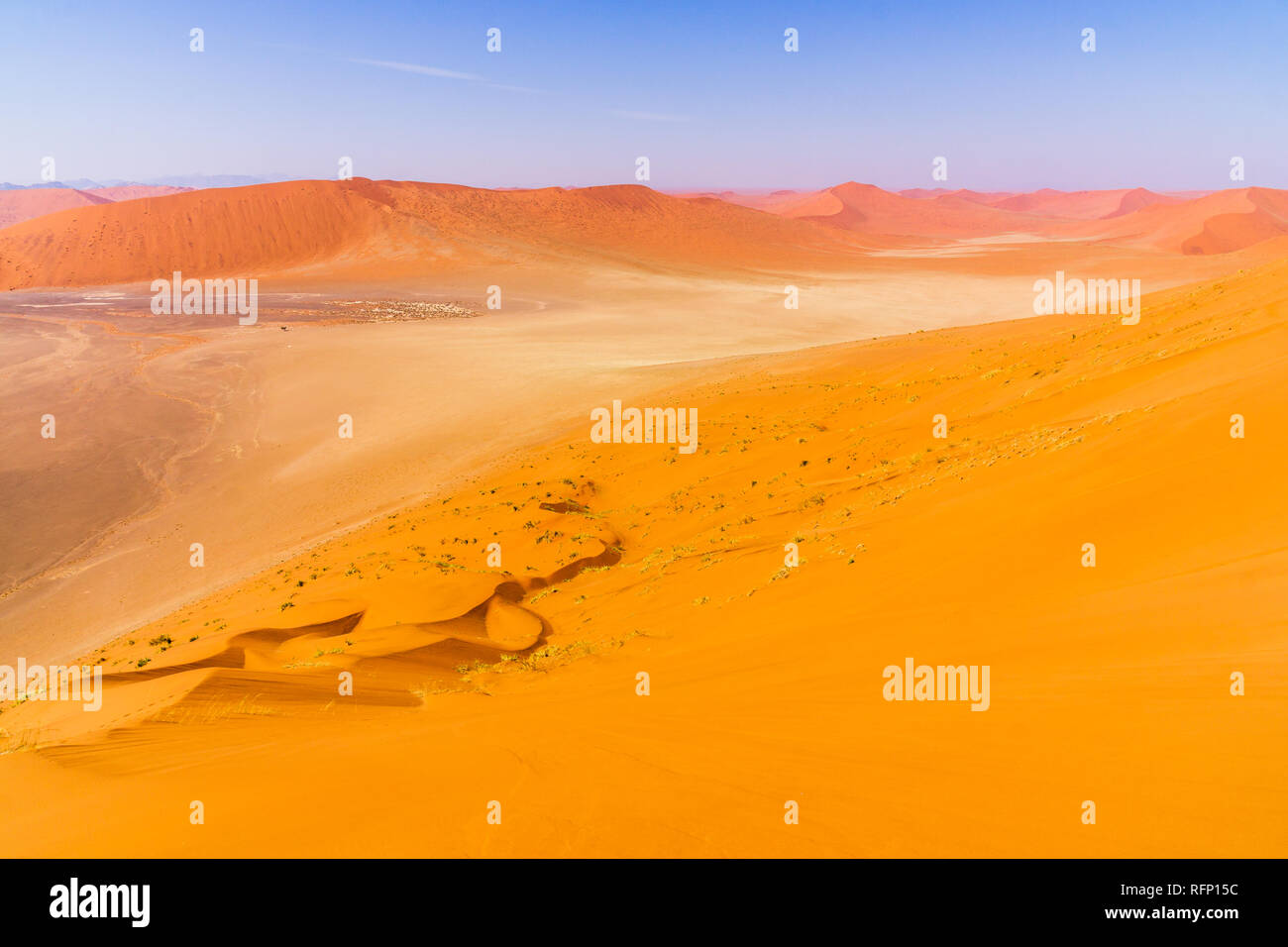 Tourist walking on the scenic dunes of Sossusvlei, Namib desert, Namib ...