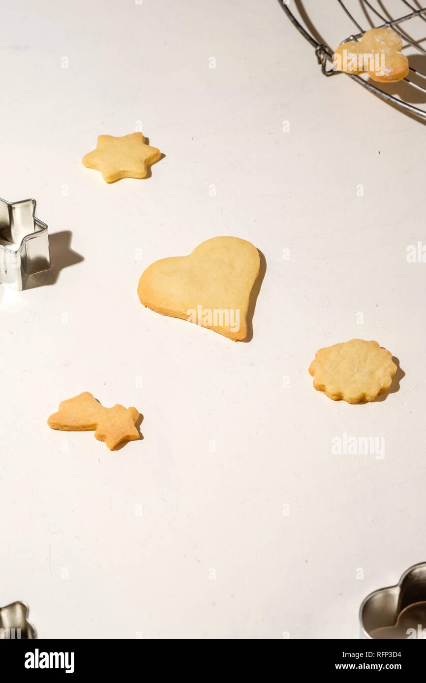 christmas biscuits on white textured background, with biscuit cutter ...