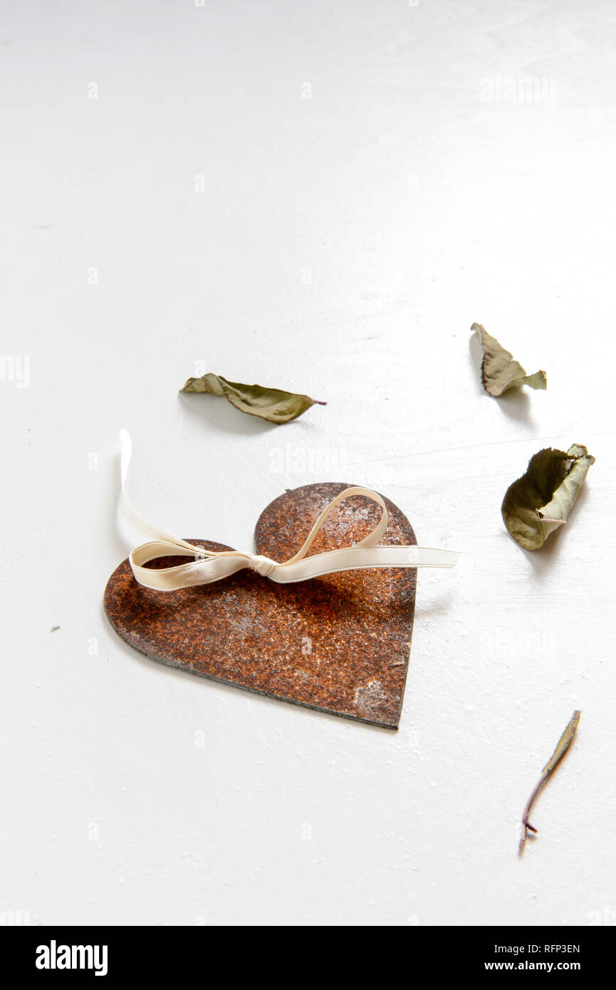 love symbol, rusty heart with dried leaves, isolated on white Stock ...