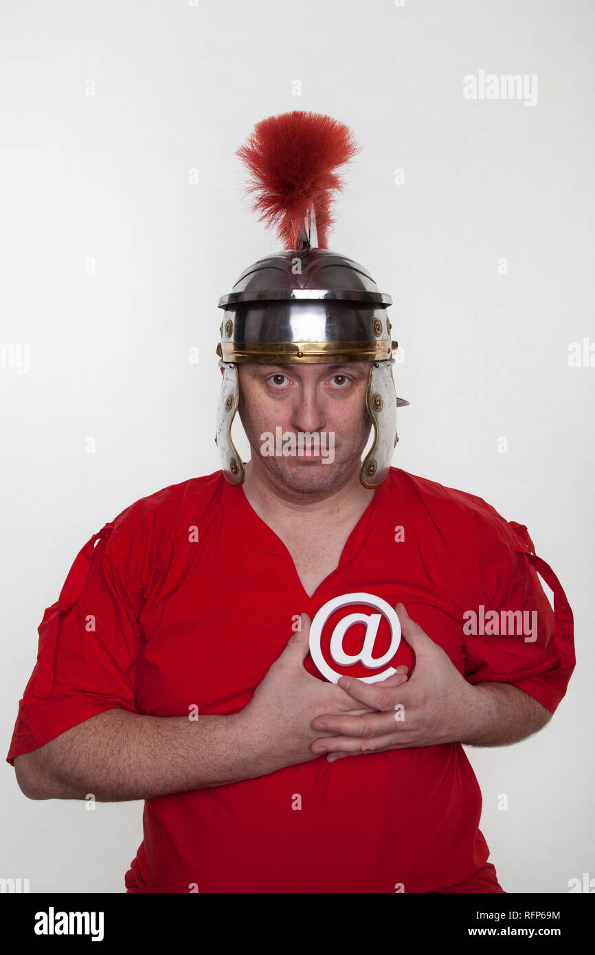 A roman soldier shows at sign at the heart area on the white background ...