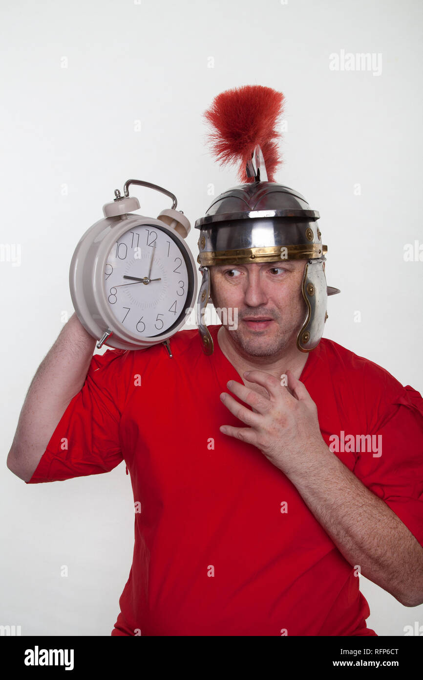 A roman soldier with a big alarm clock on the white background Stock ...