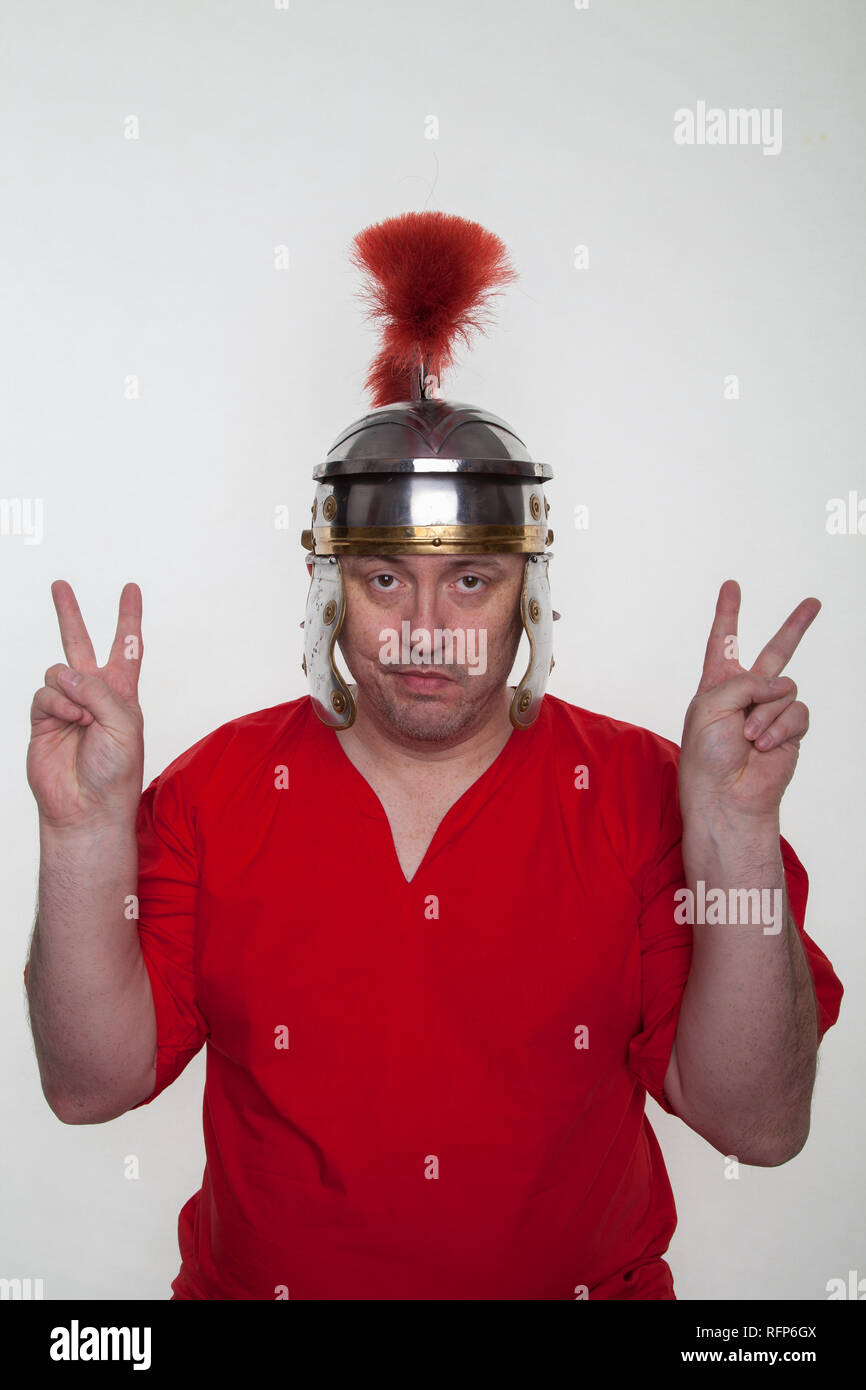 A roman soldier shows peace sign on the white background Stock Photo ...