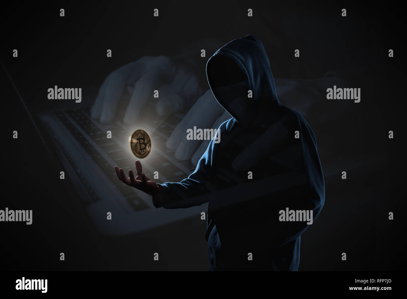 Golden Bitcoin floating above of hacker's hand in dark on hacker ...