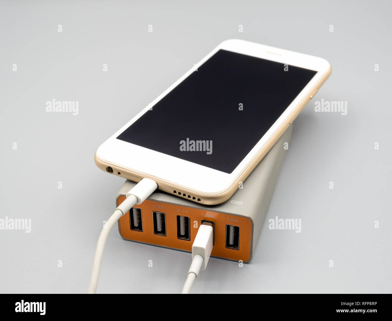 Smart phone charging with multiport USB power adaptor on gray ...